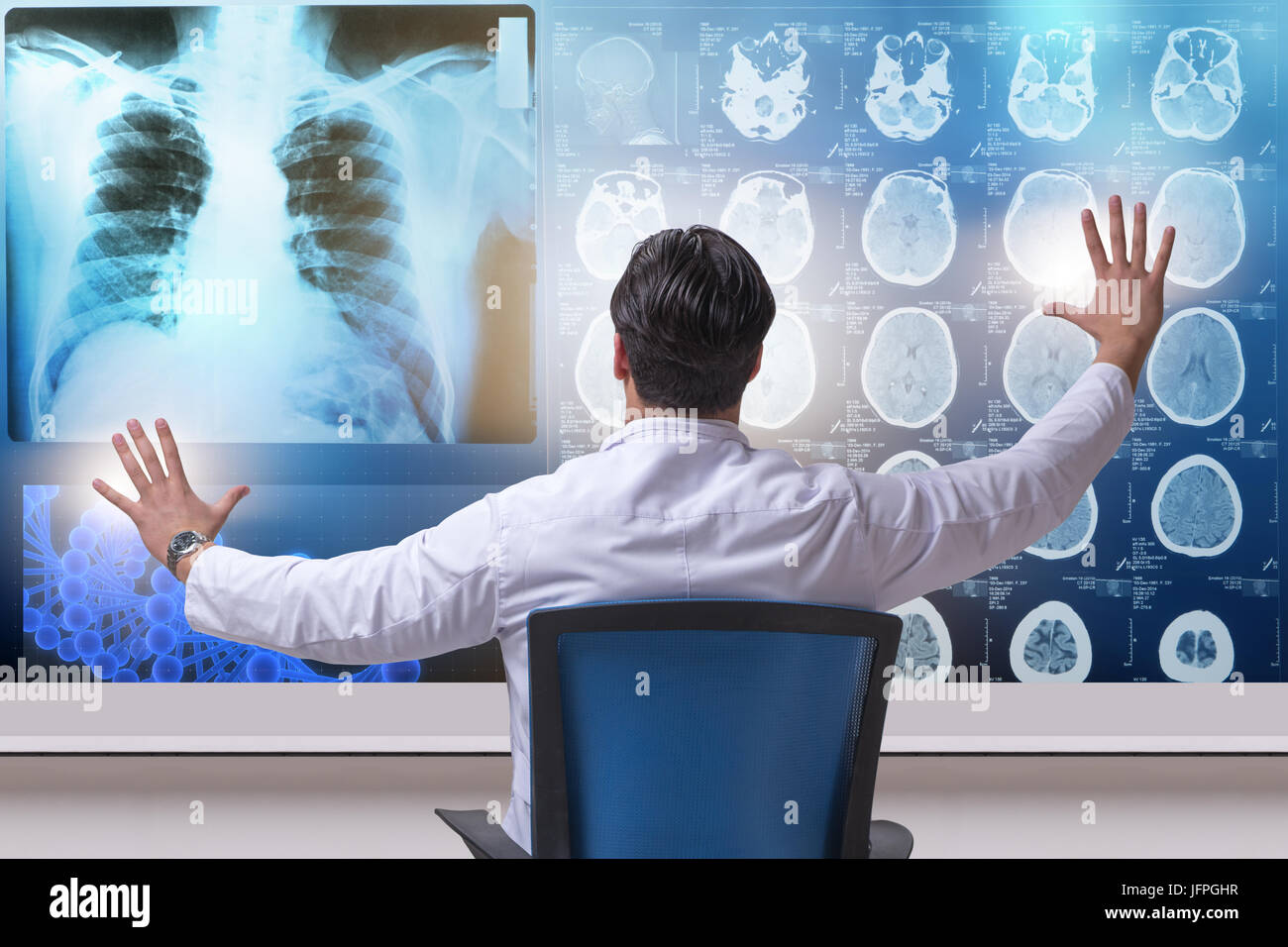 Male doctor looking at MRI scans Stock Photo - Alamy