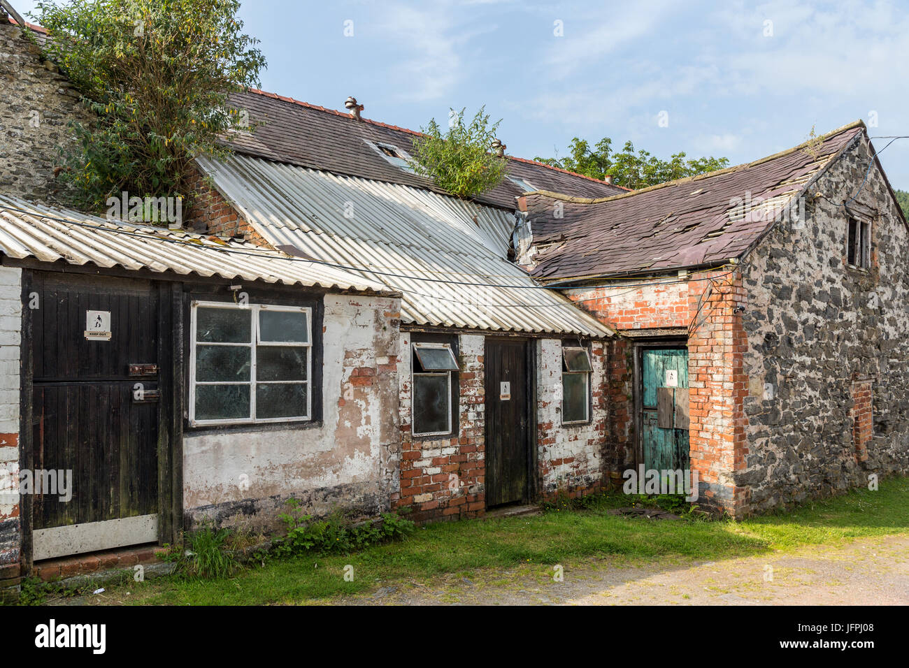 Derelict farm buildings with keep out signs, Tower Farm, Llangollen ...
