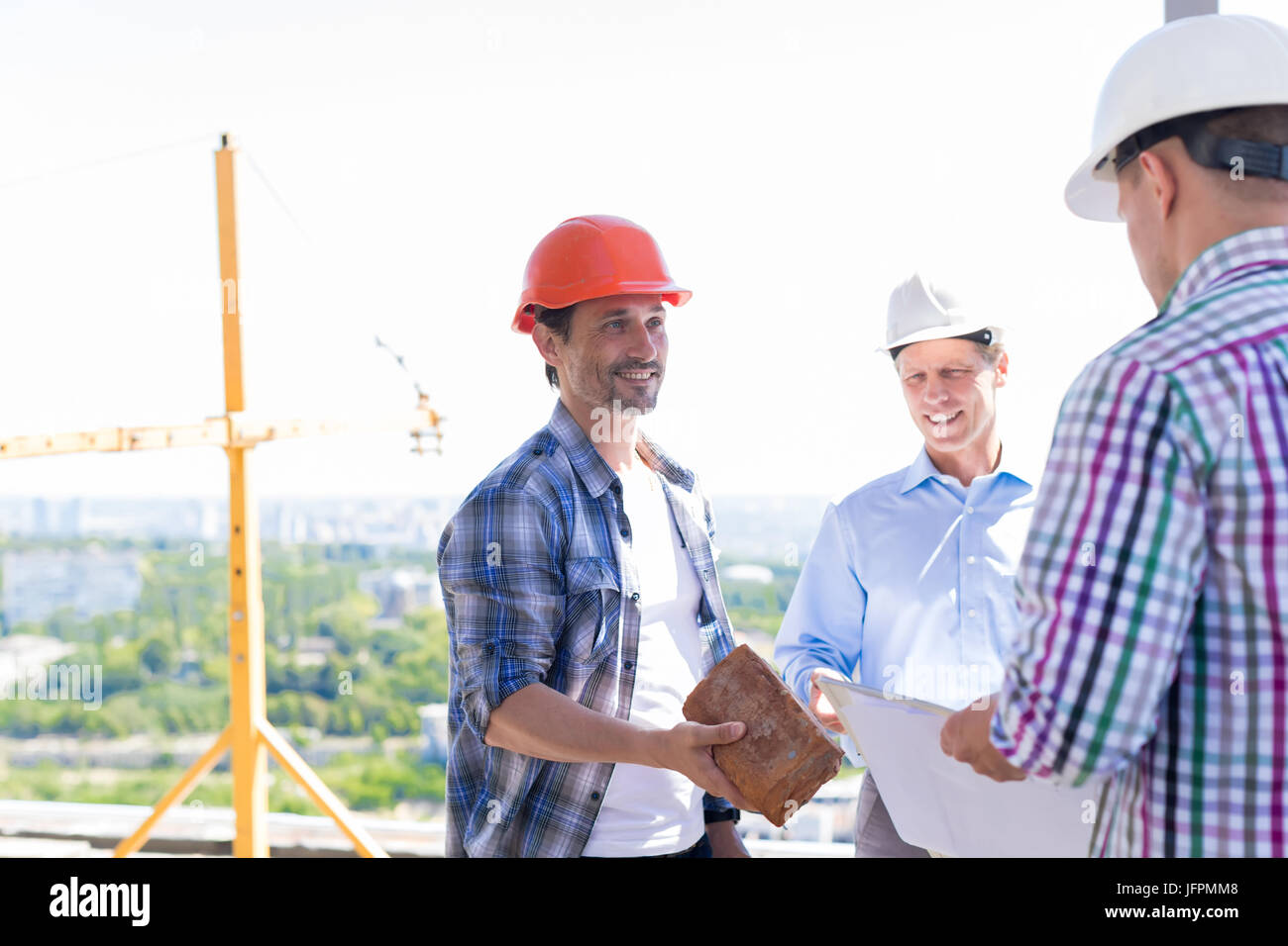 Team Of Builders On Construction Site, Contractor Giving Apprentice ...