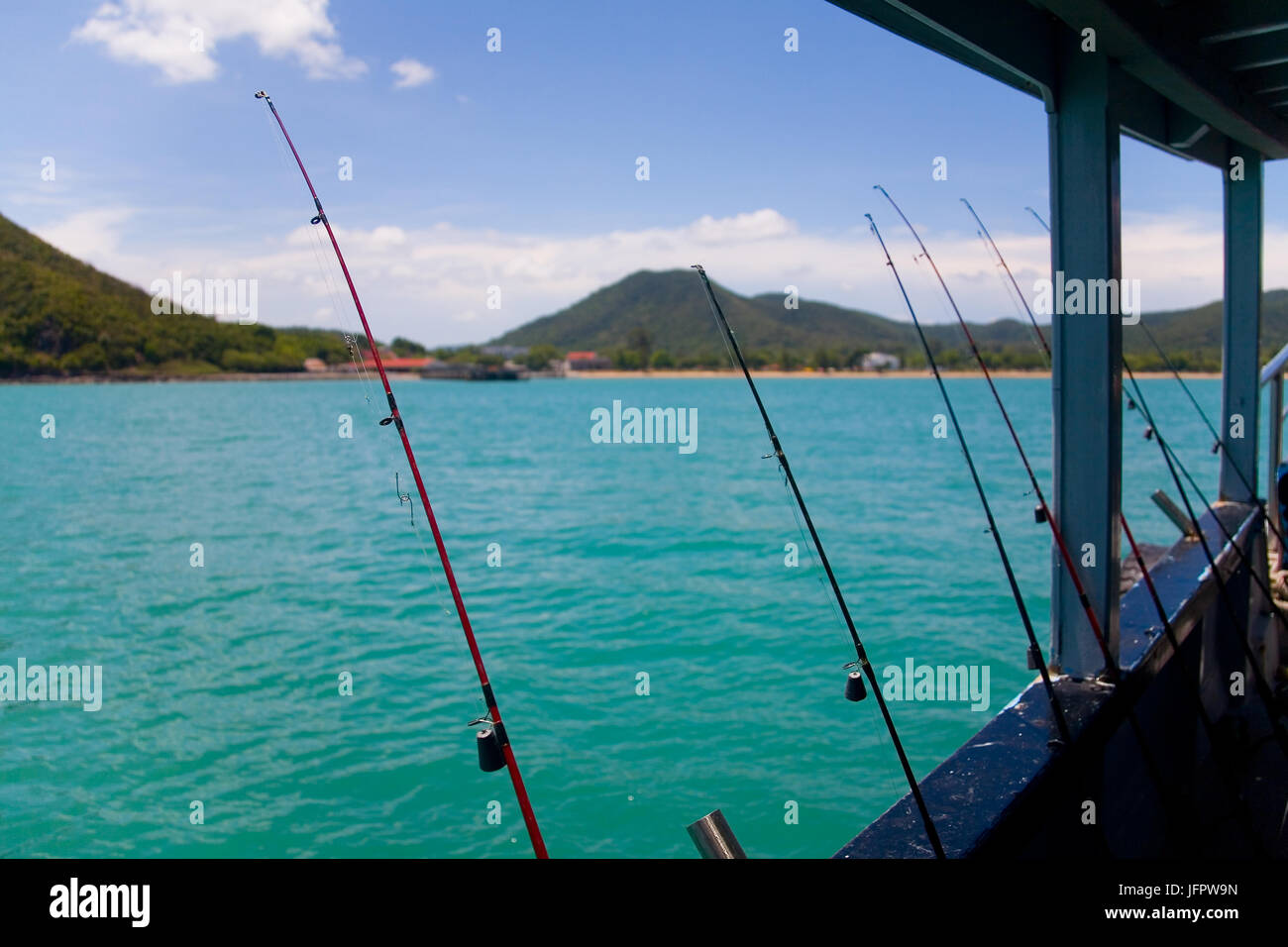 Sea fishing. The fishing rods are leaning against the side of the ship ...