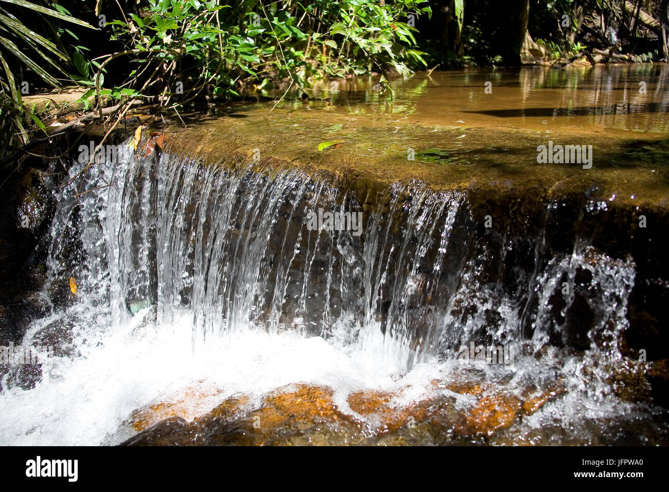Nature. A small tropical waterfall with clear water Stock Photo - Alamy