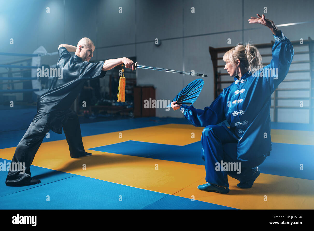 Wushu fighters, man with sword and woman with fan, martial arts culture ...