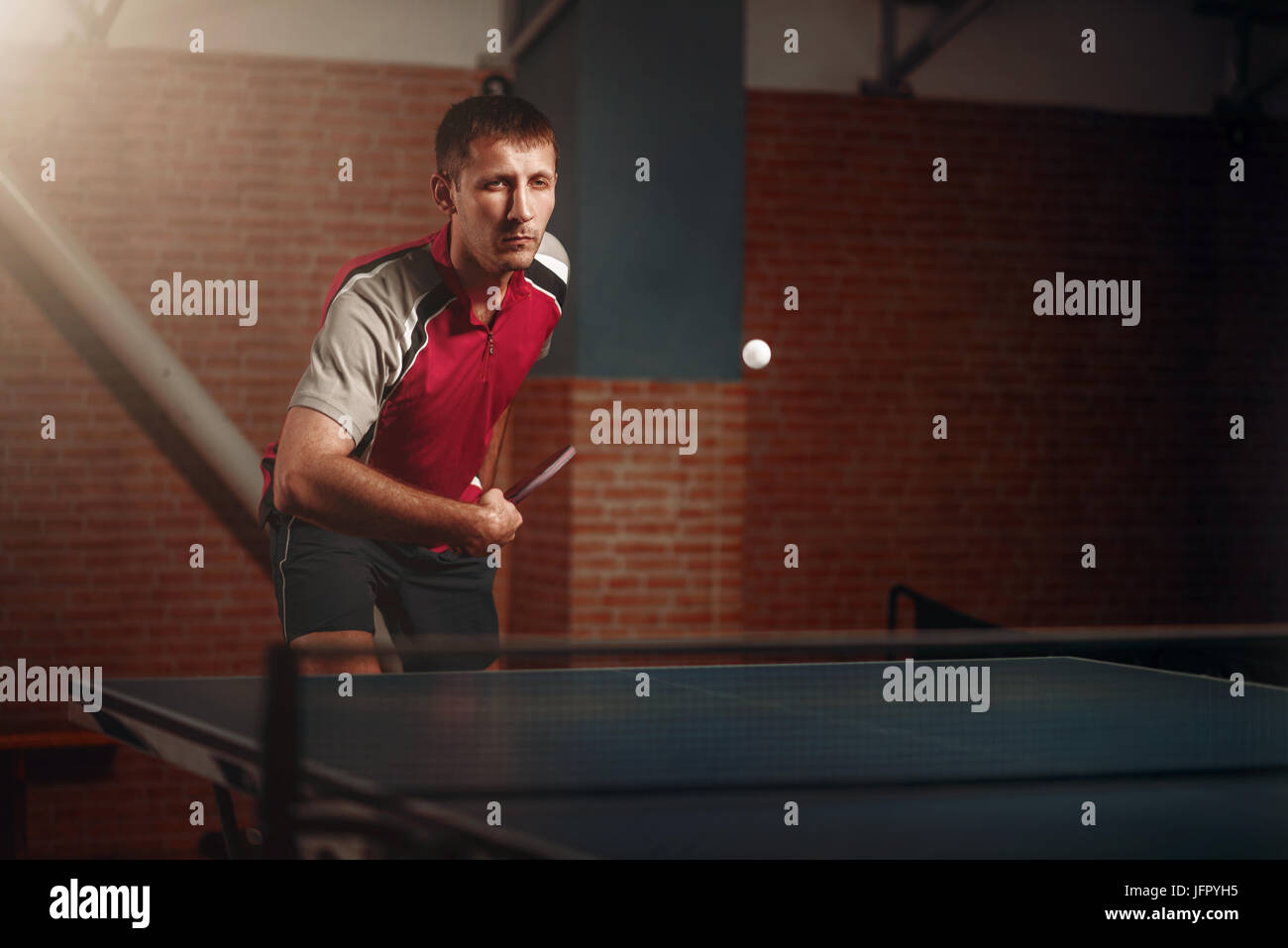 Table tennis, male player with racket in action, ball with trace. Ping ...