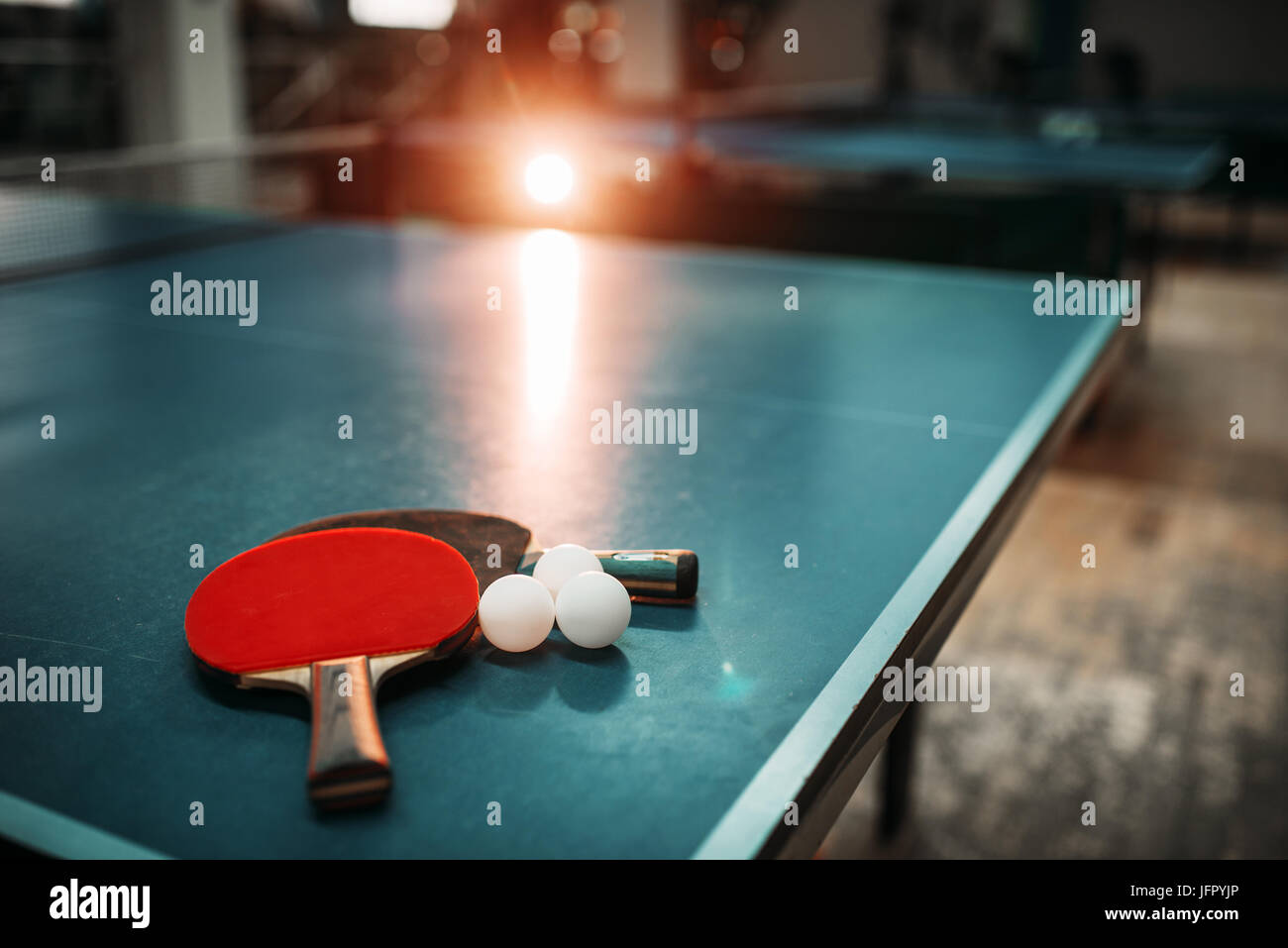 Ping pong table with rackets and balls in a sport hall, game equipment ...