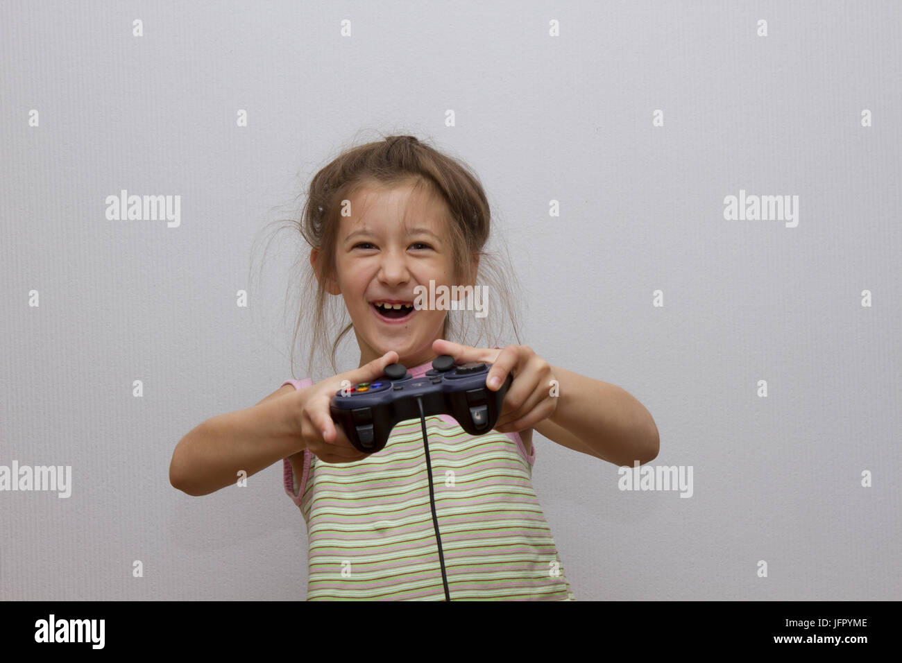 Happy Caucasian girl playing video games holding game controller Stock ...