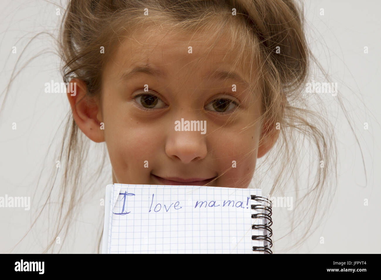 Little girl writing "I Love my mom Stock Photo - Alamy