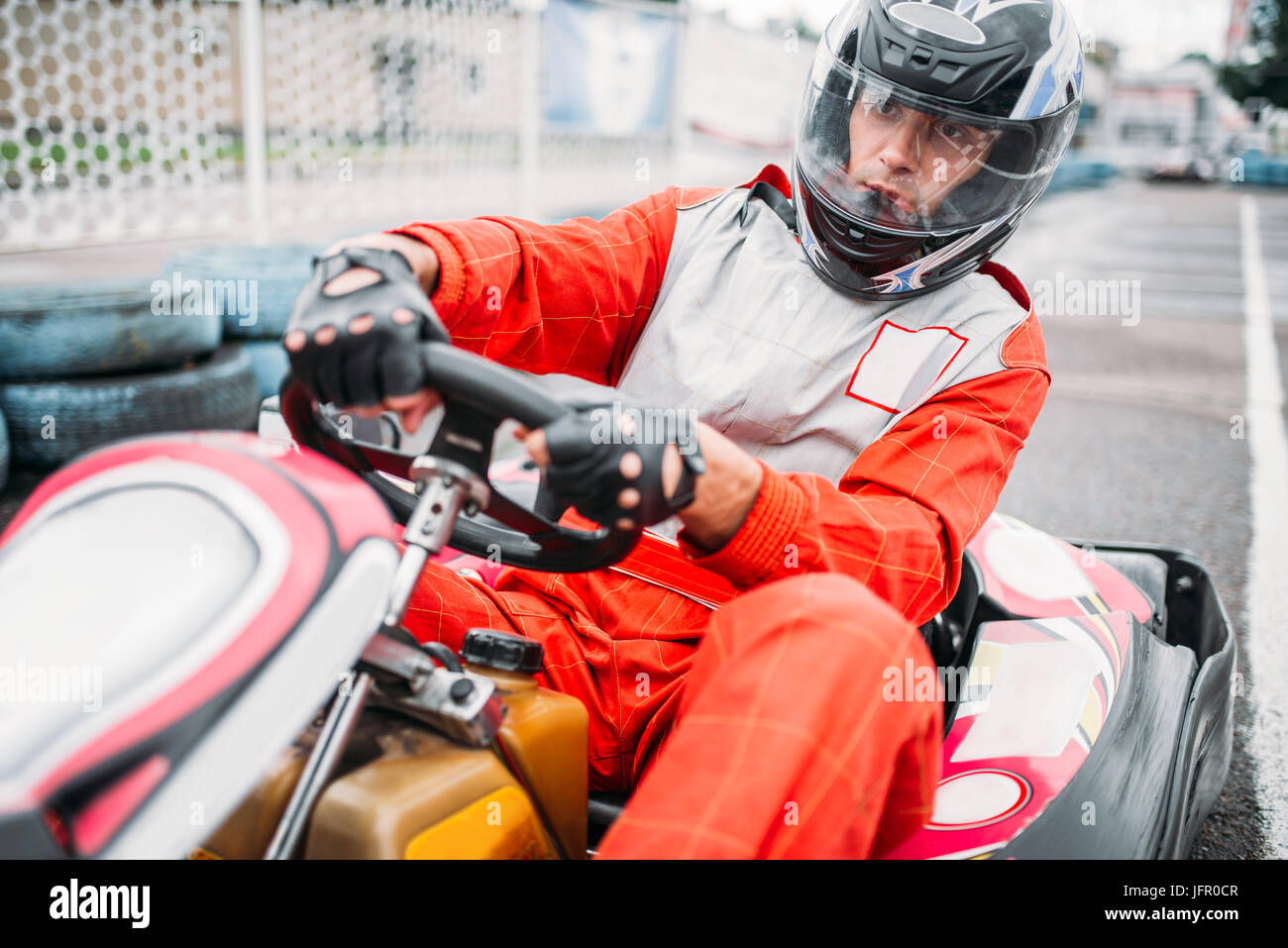 Karting race, go cart driver in helmet on carting speed track. Go-kart ...