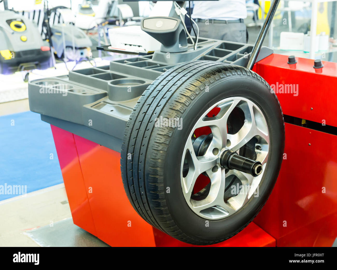 Computer wheel balancing on special machine. Tire service shop. Tyre ...