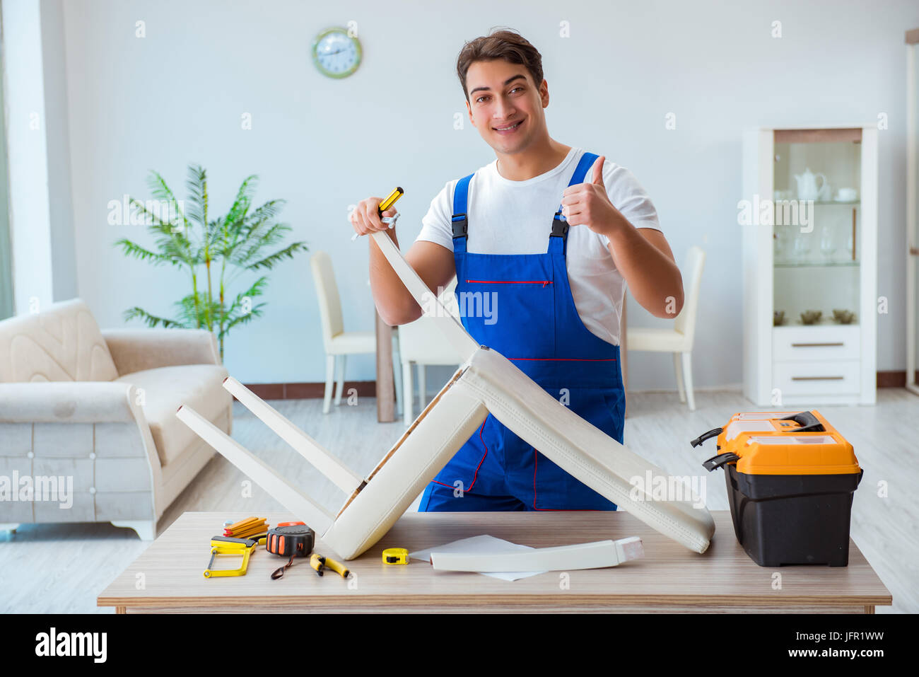 Repairman repairing broken chair at home Stock Photo - Alamy
