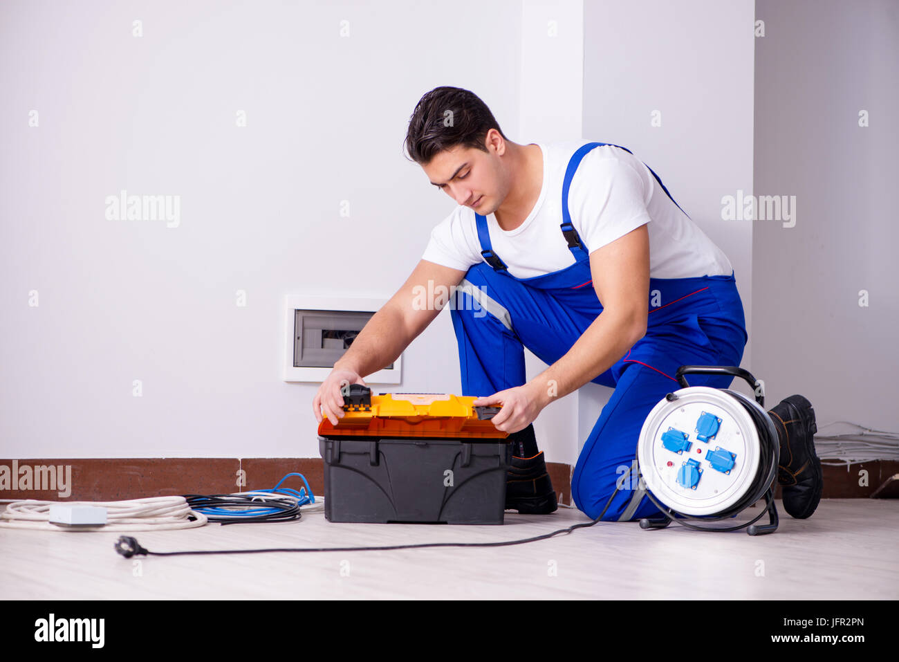 Man doing electrical repairs at home Stock Photo - Alamy