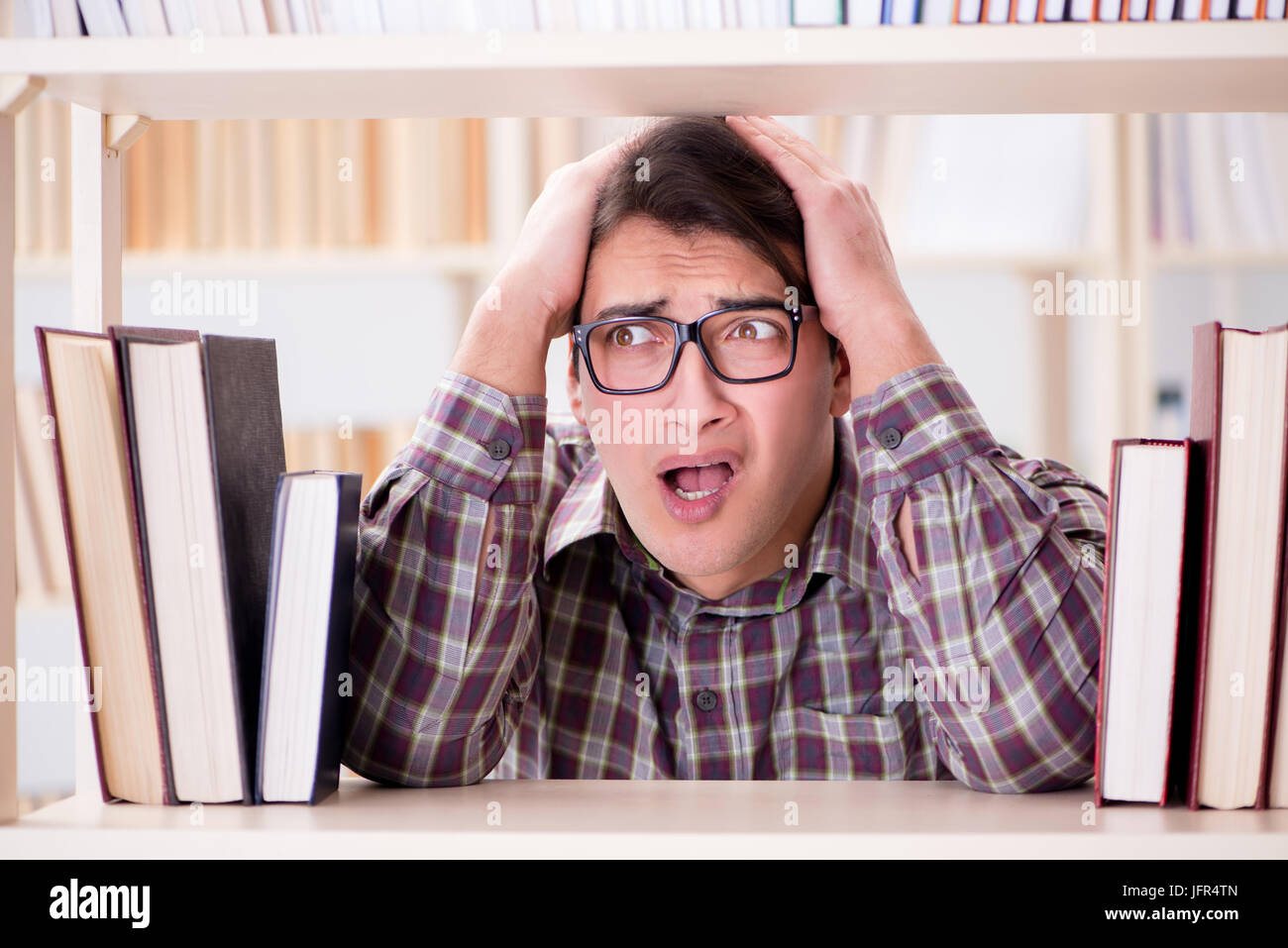 Scared male student books hi-res stock photography and images - Alamy