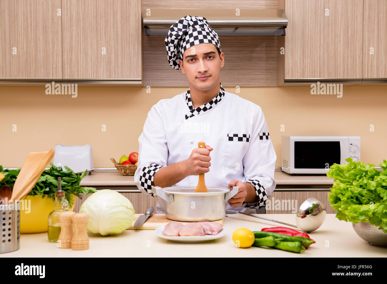 Young chef working in the kitchen Stock Photo - Alamy
