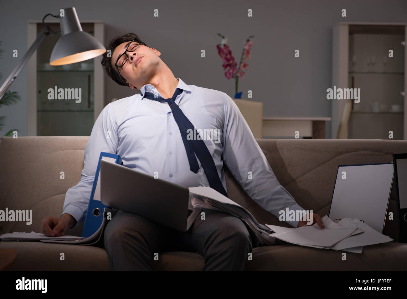 The businessman workaholic working late at home Stock Photo - Alamy