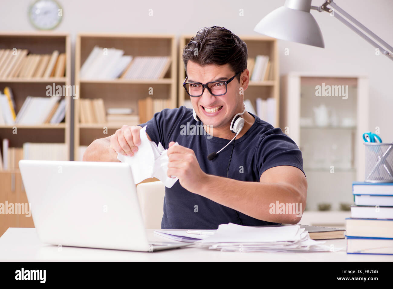 The angry man tearing apart his paperwork due to stress Stock Photo - Alamy