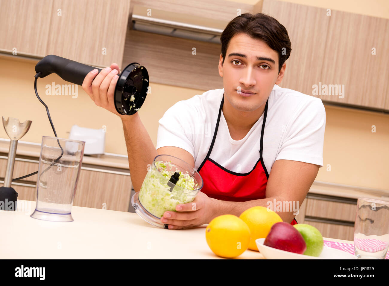 The handsome man working at the kitchen Stock Photo - Alamy