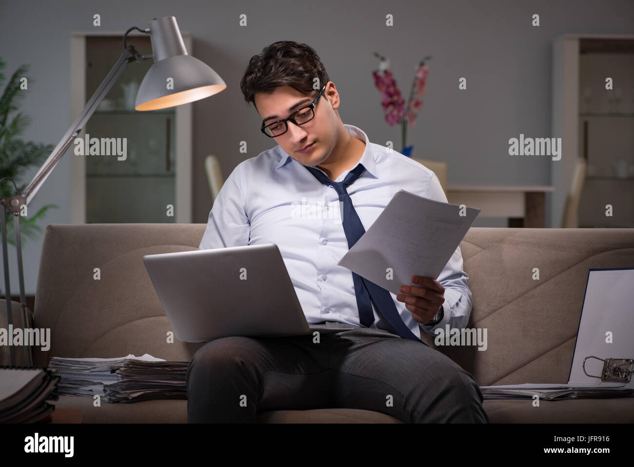 The businessman workaholic working late at home Stock Photo - Alamy