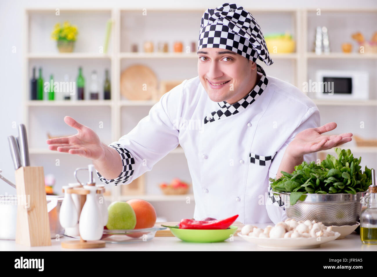 The young male cook working in the kitchen Stock Photo - Alamy