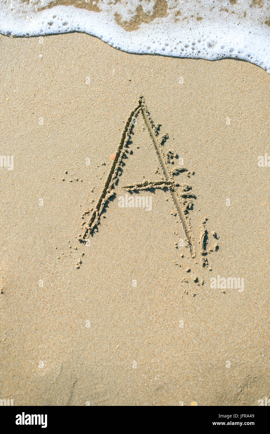 Letter drawn on the sand beach Stock Photo - Alamy