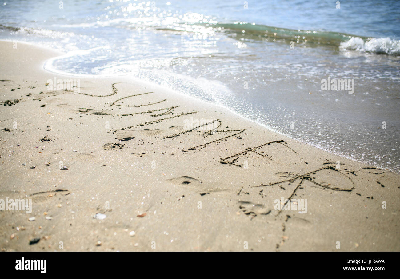 Letter drawn on the sand beach Stock Photo - Alamy