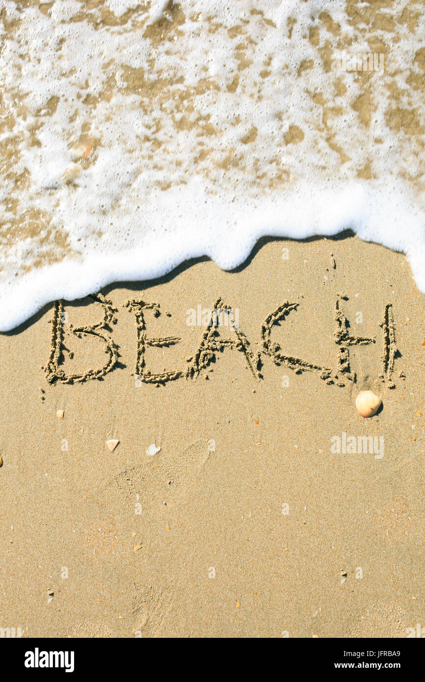 Letter drawn on the sand beach Stock Photo - Alamy