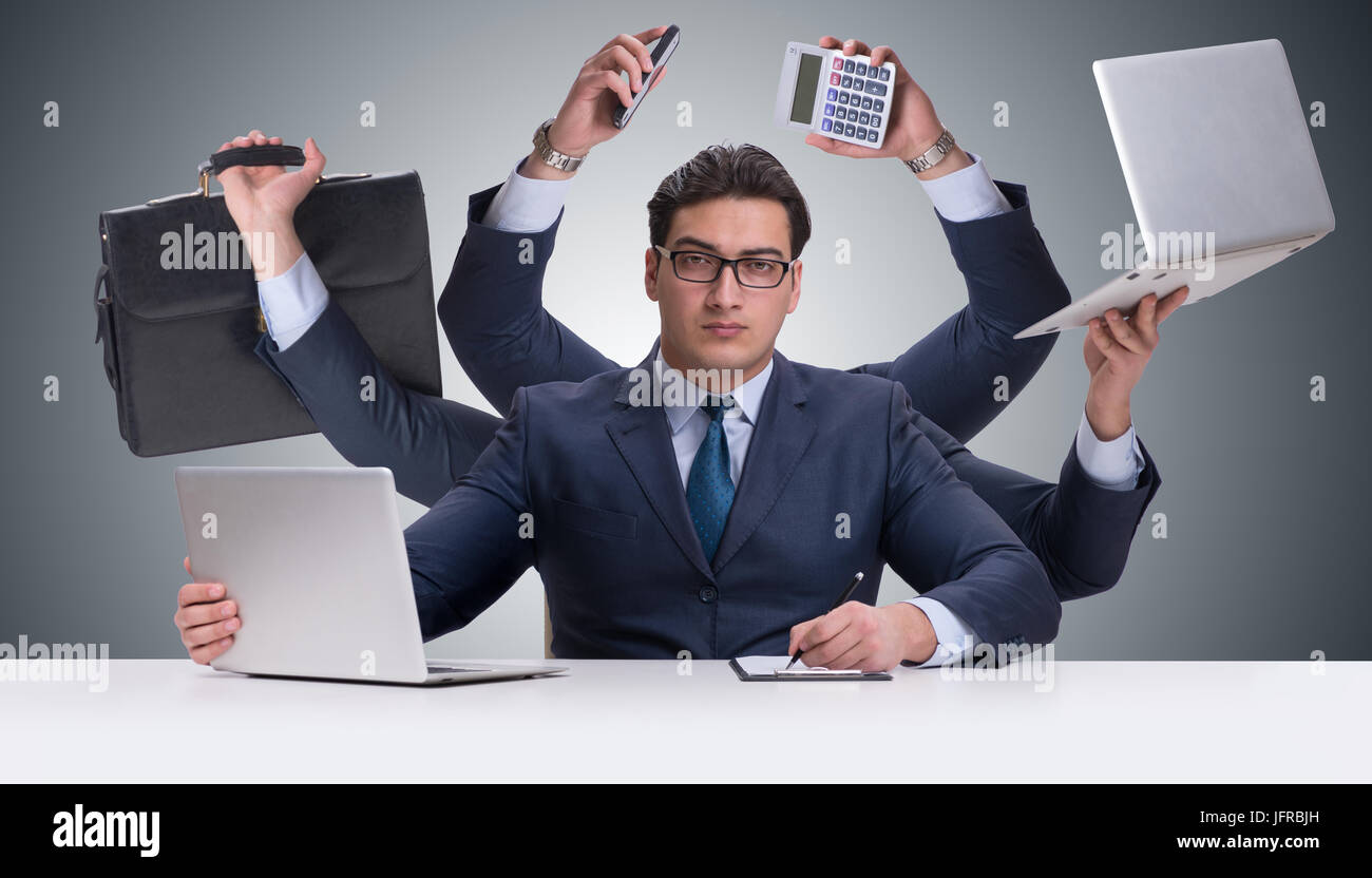 The young businessman in multitasking concept Stock Photo - Alamy