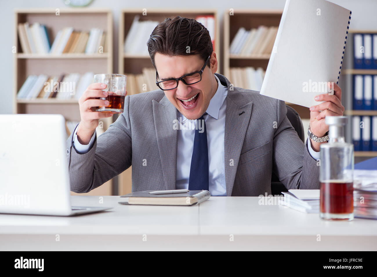 The businessman drinking in the office Stock Photo - Alamy