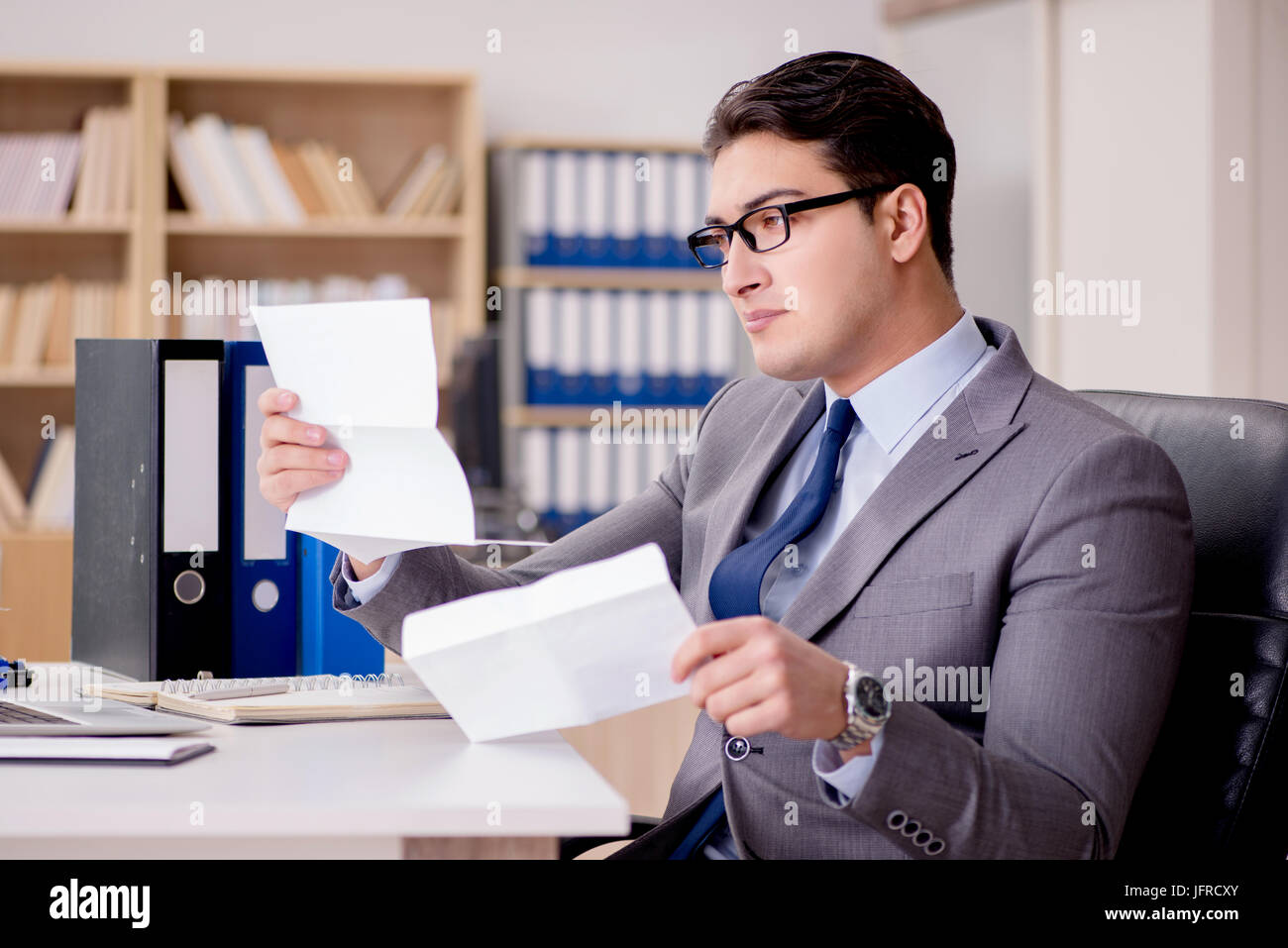 The businessman receiving letter envelope in office Stock Photo - Alamy