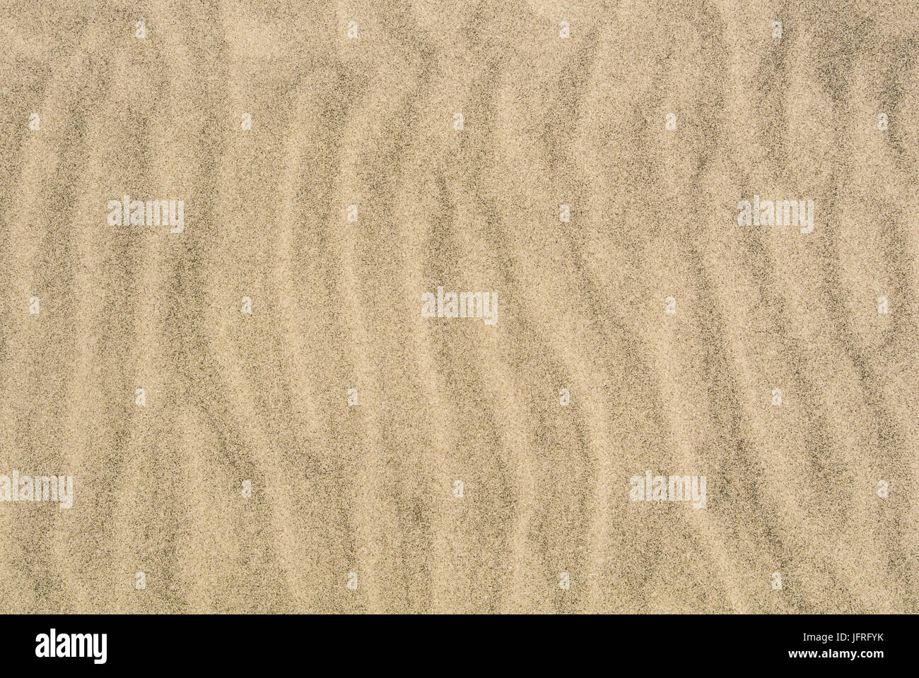 A sand texture, close-up macro view to a sand of a beach with shapes ...