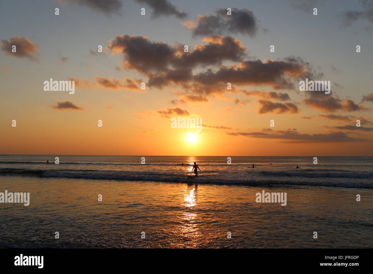 Surfer in the sunset Stock Photo - Alamy