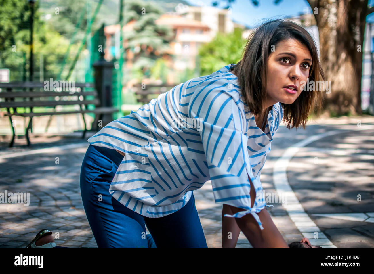 girl trying to find help for an unconscious guy Stock Photo - Alamy