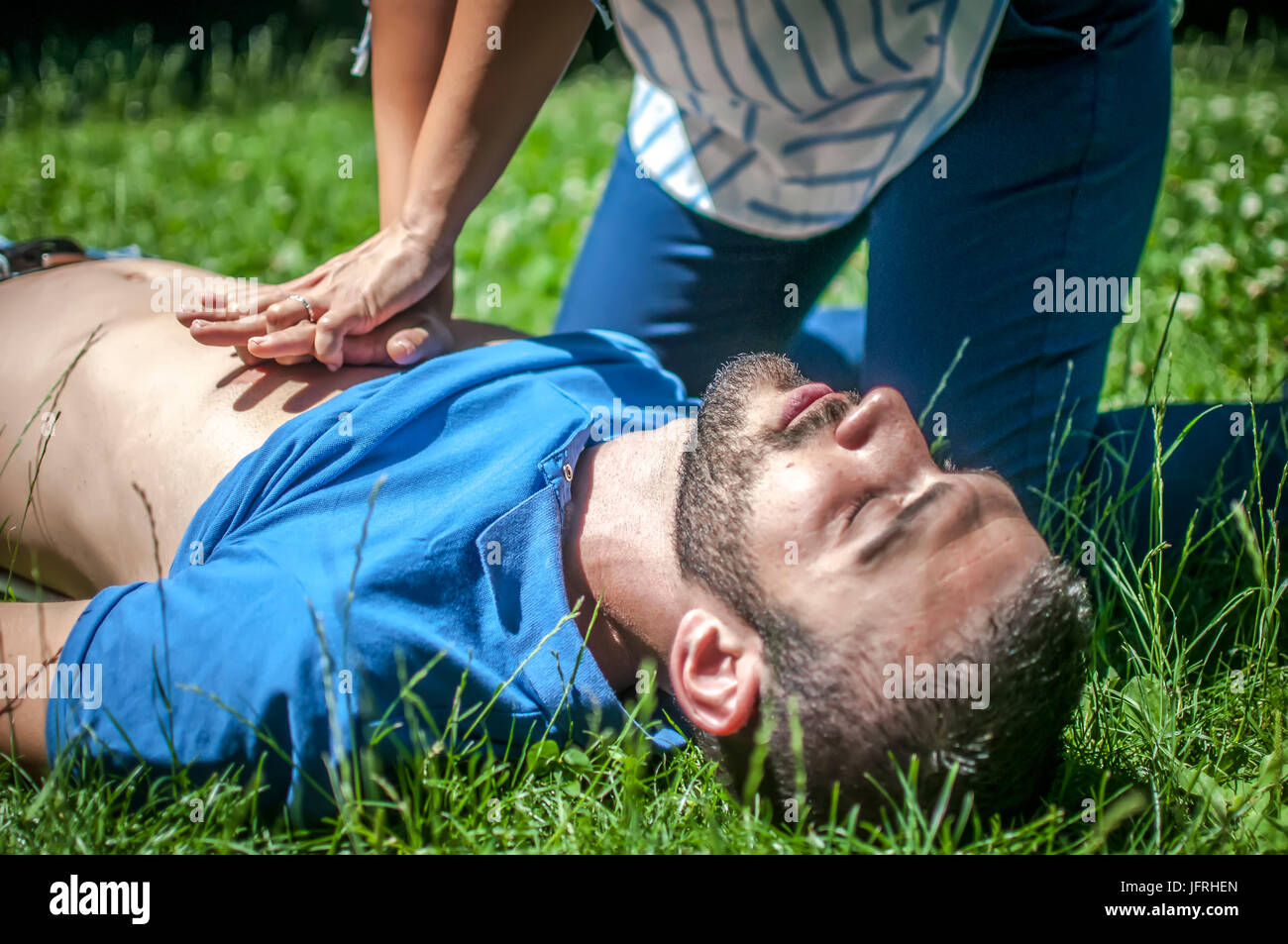 girl making reanimation to an unconscious guy after heart attack Stock ...