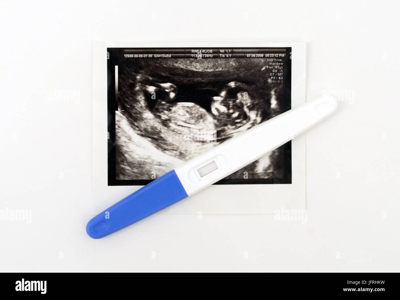 Plastic pregnancy test and ultrasound picture Stock Photo - Alamy