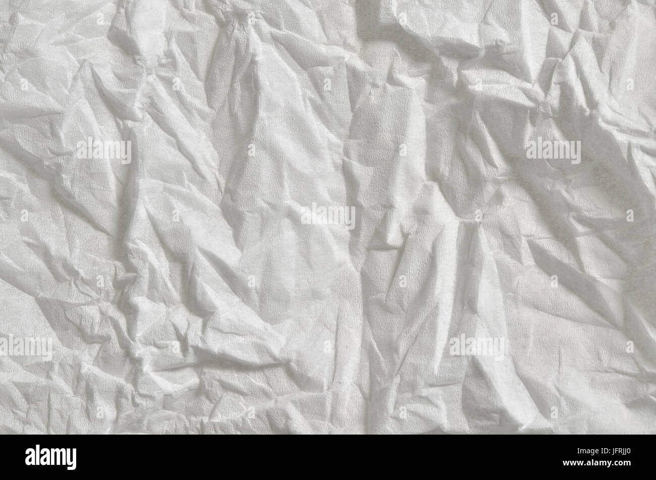 close up of a creased, white, soft paper texture, full frame ...