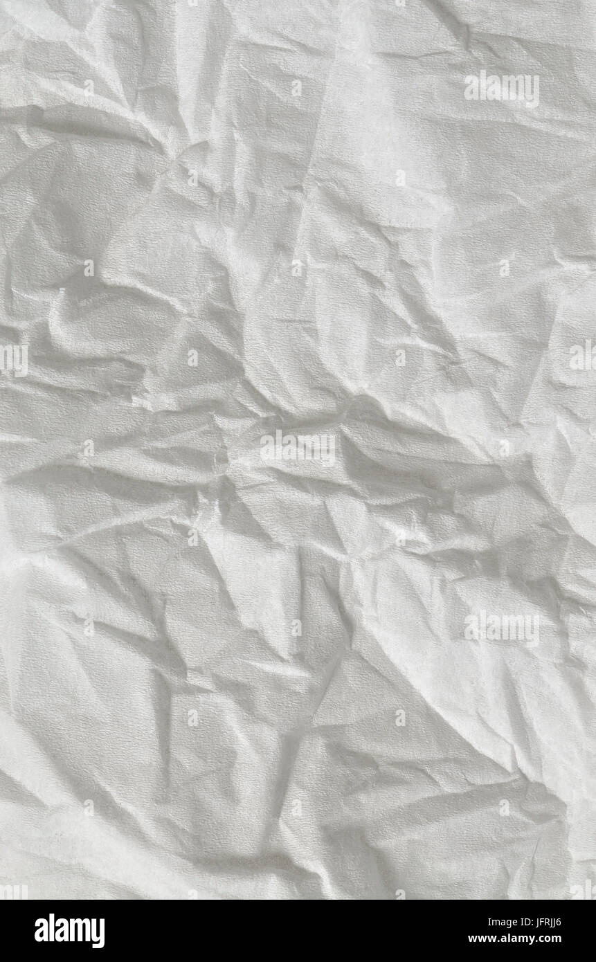 close up of a creased, white, soft paper texture, full frame, vertical ...