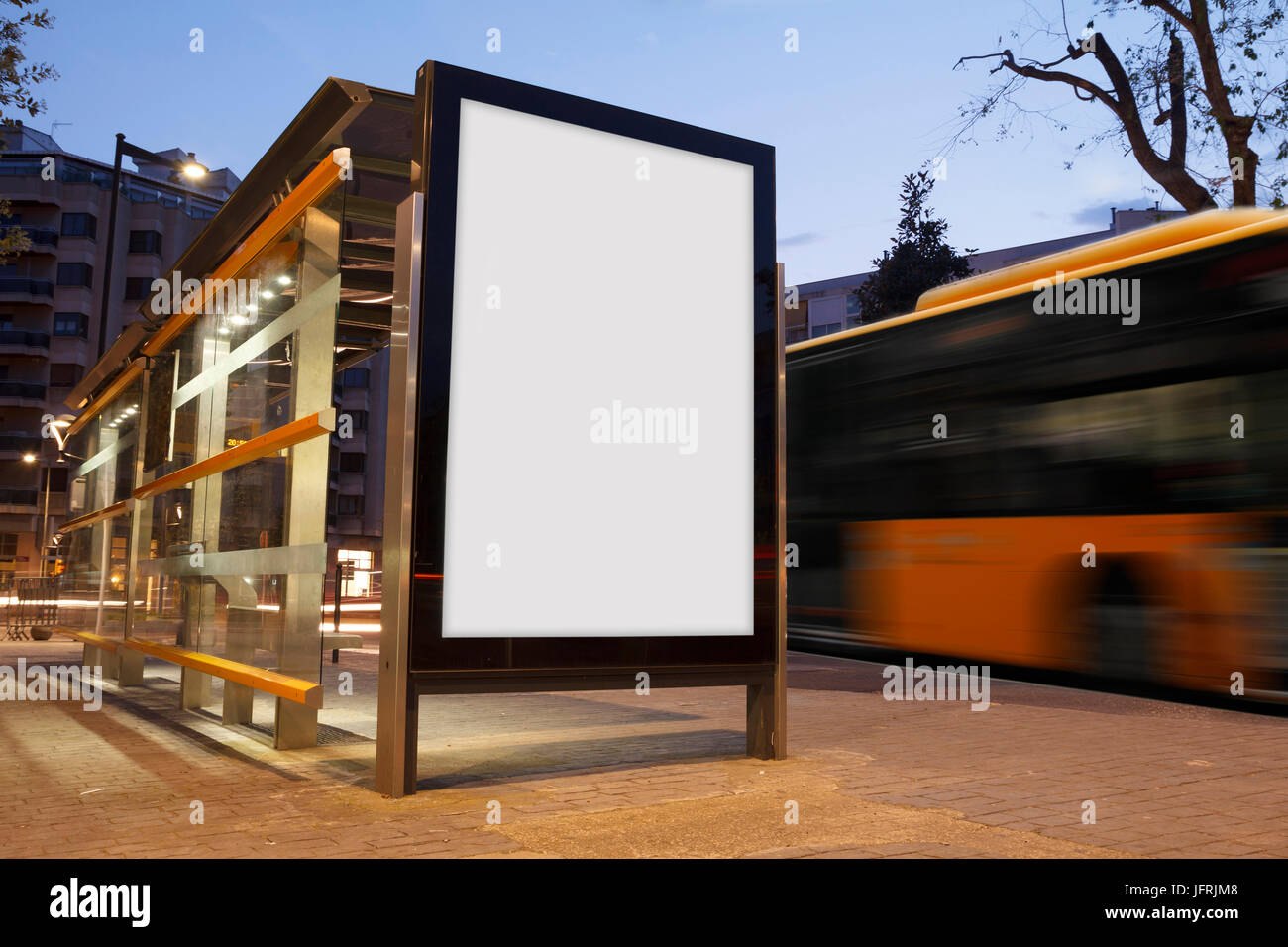 Blank advertisement in a bus stop, with blurred bus Stock Photo - Alamy