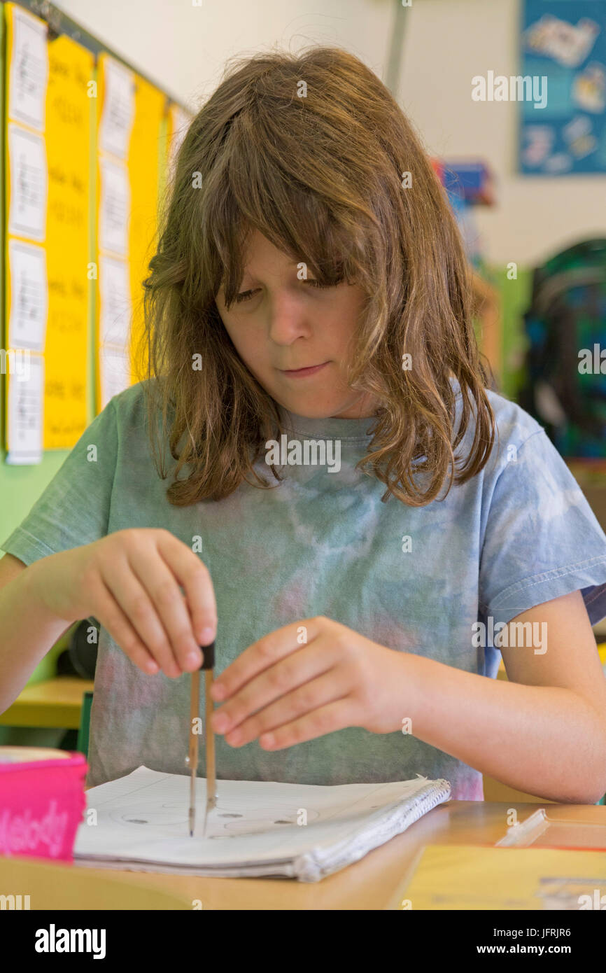 primary school girl working with her compasses Stock Photo - Alamy