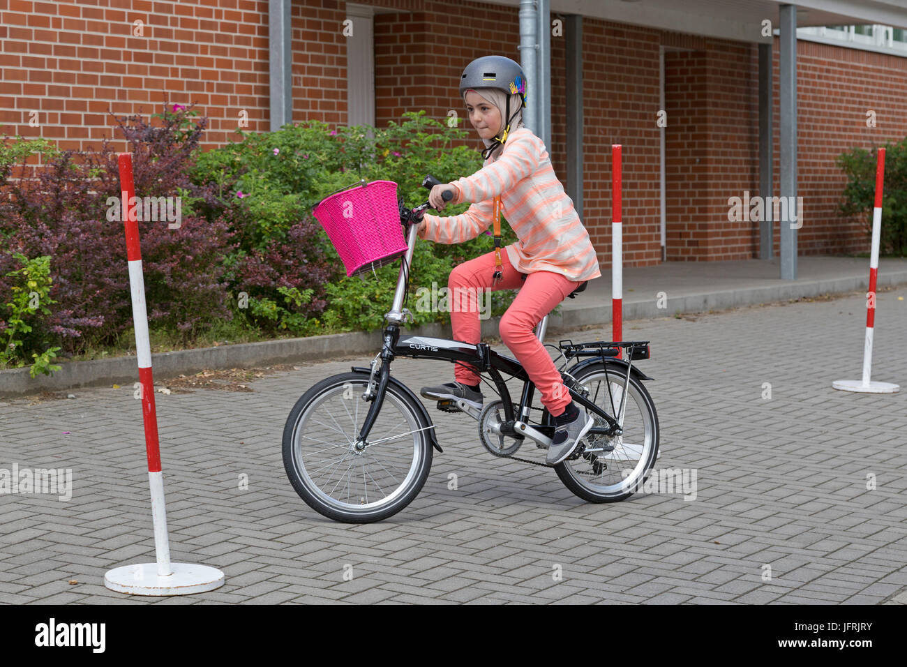 primary school girl during cycling lesson Stock Photo - Alamy
