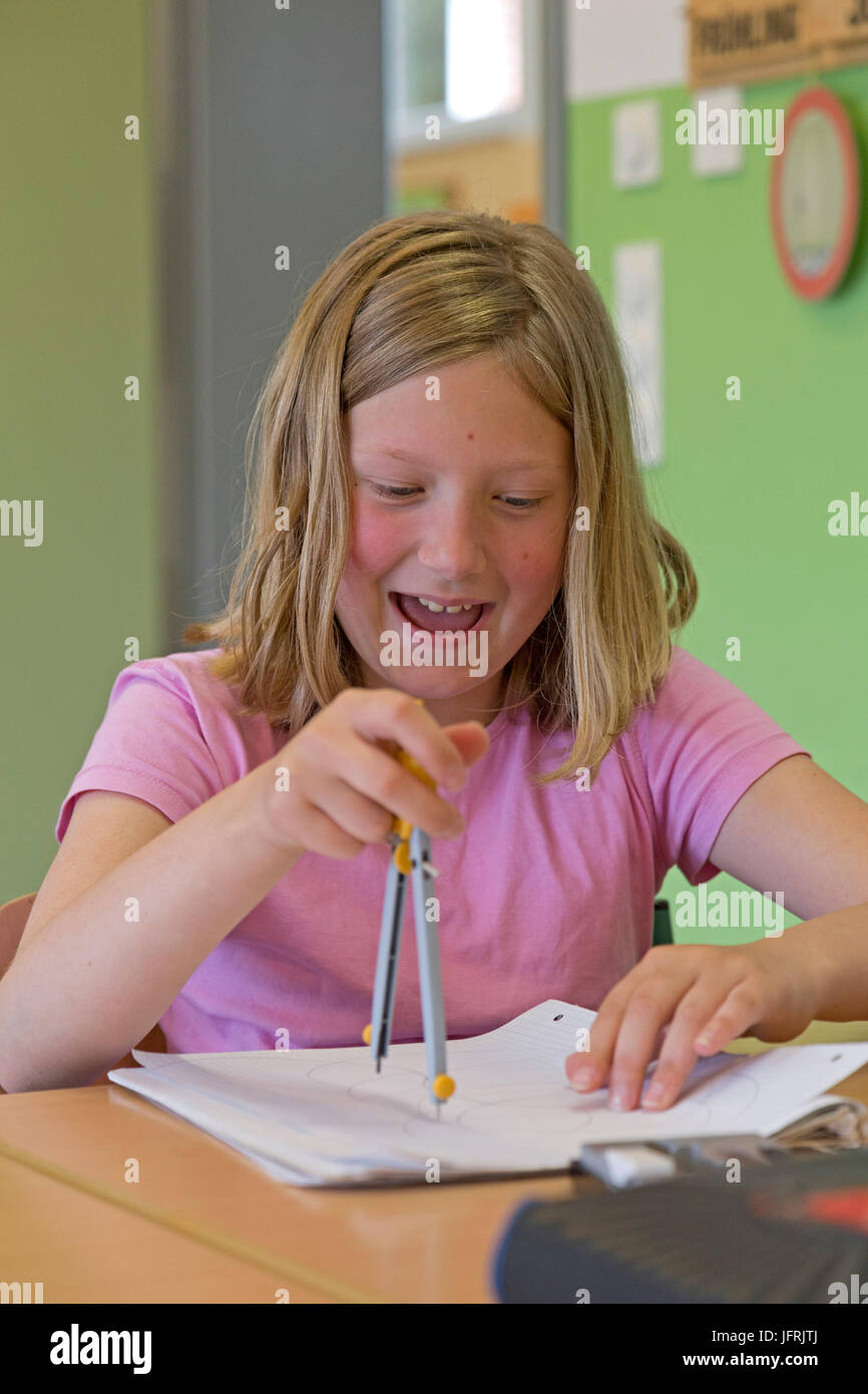 girls at primary school working with her compasses Stock Photo - Alamy