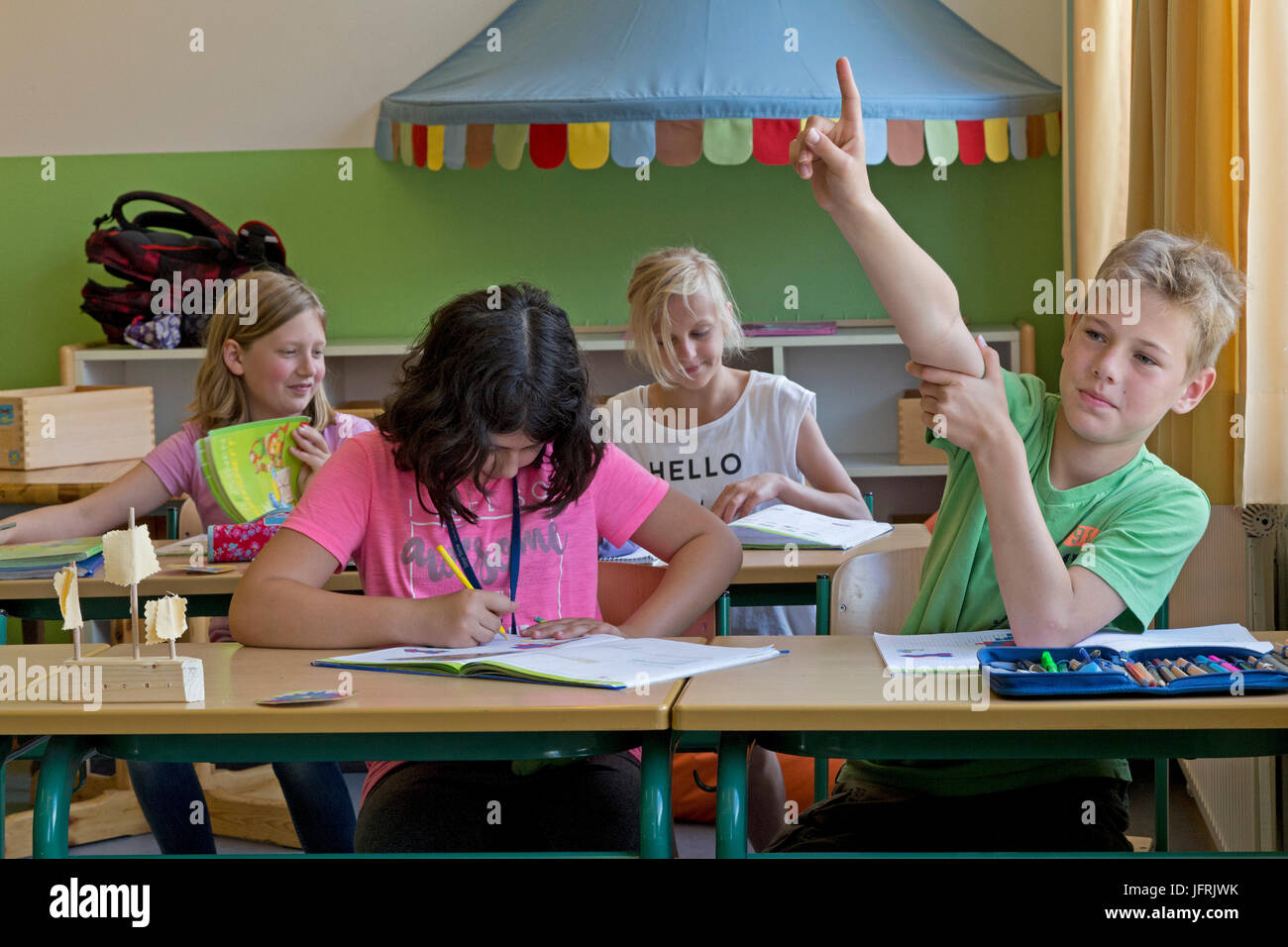 pupils at primary school raising their hands Stock Photo - Alamy