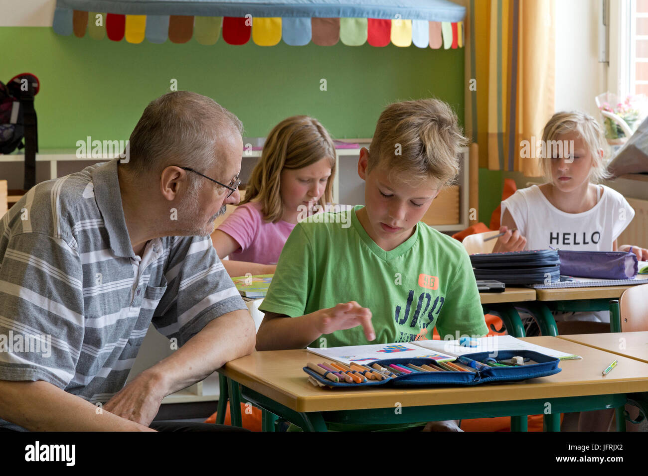 primary school boy with school escort at primary school Stock Photo - Alamy