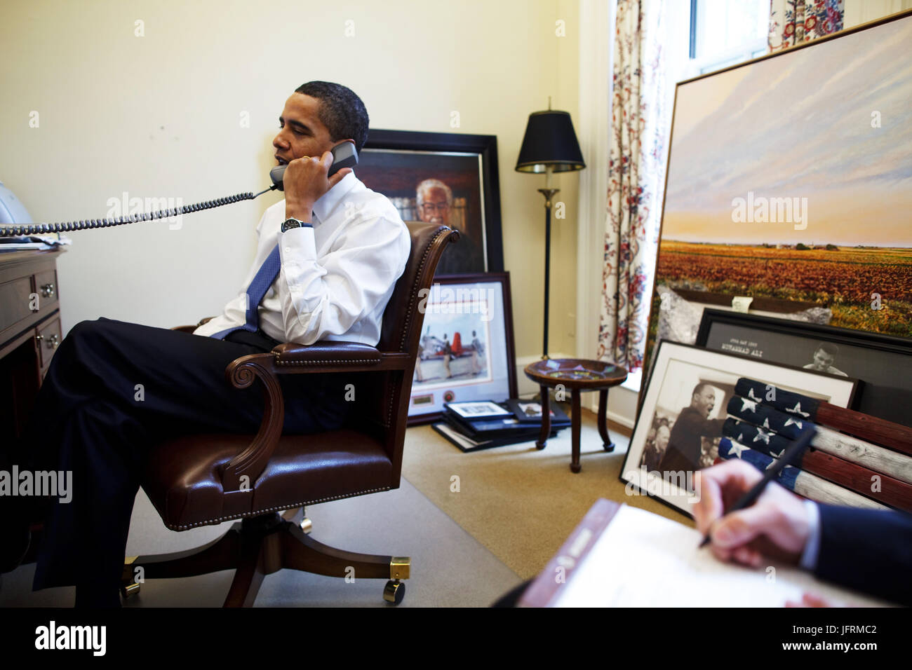 President Barack Obama takes a phone call in his private study off the ...