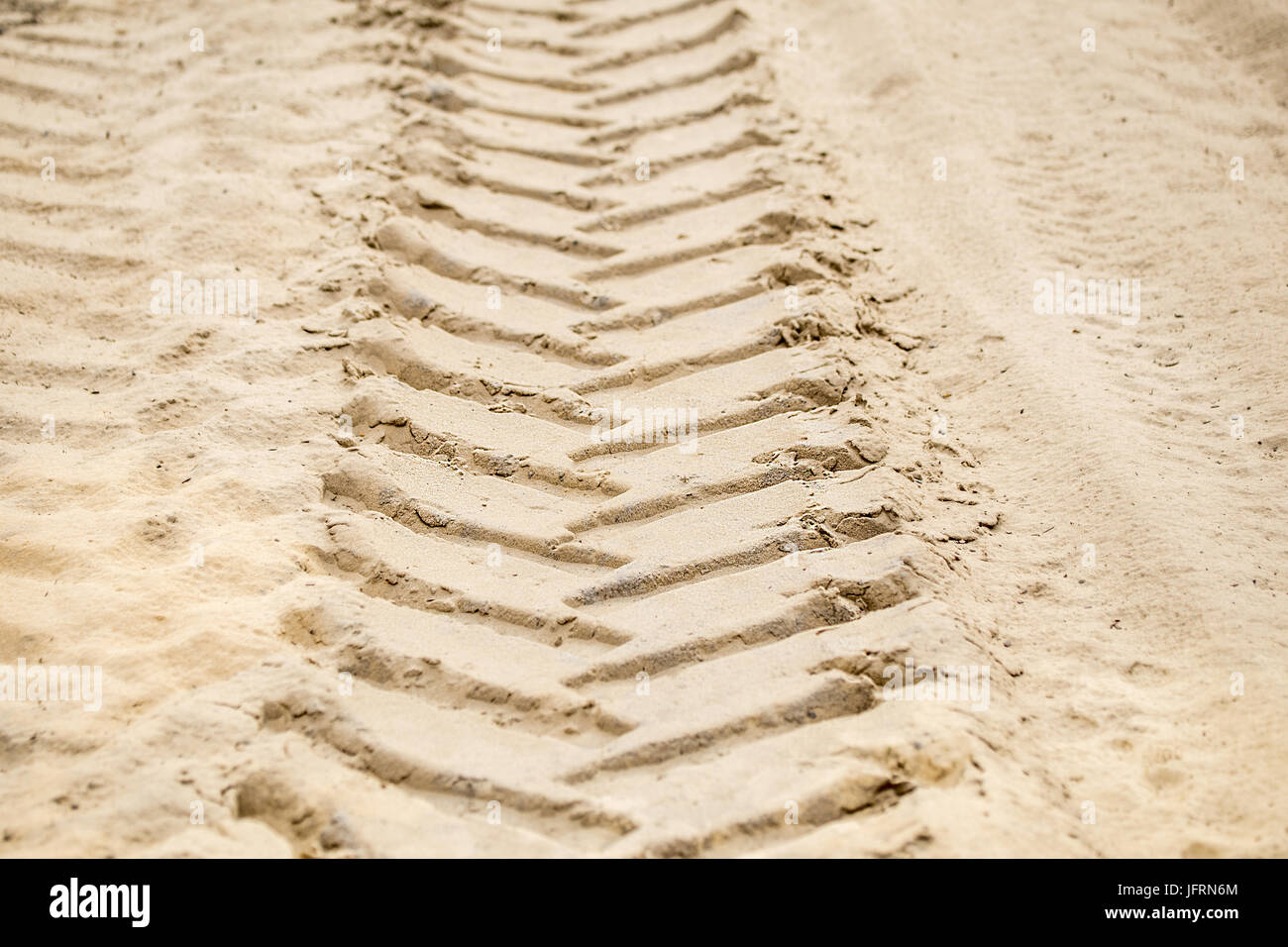 A trace on a sand of big wheel truck or tractor Stock Photo - Alamy