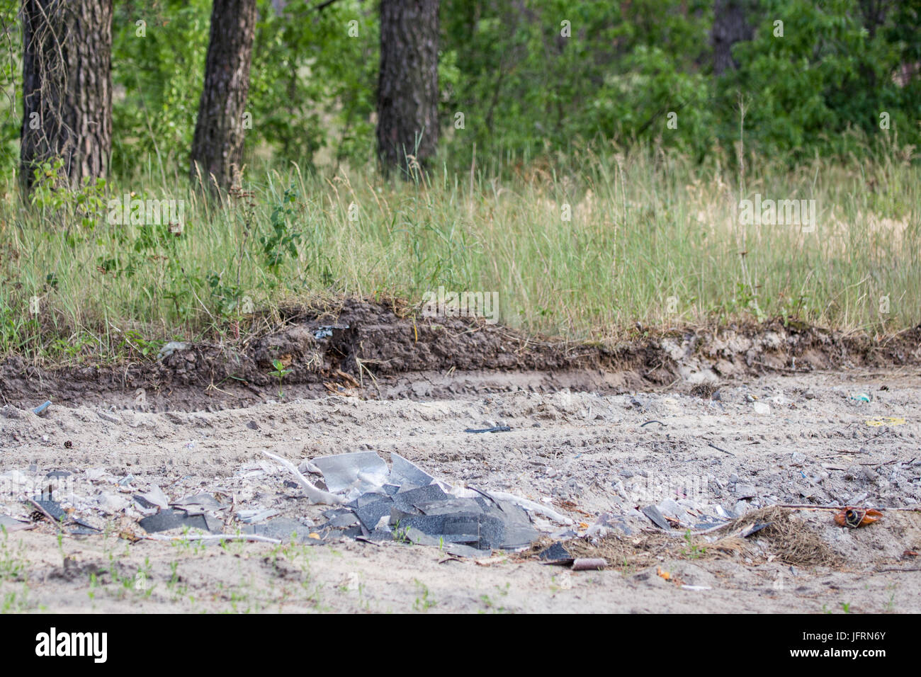 Ecological catastrophe. Forest road polluted with plastic and hard ...