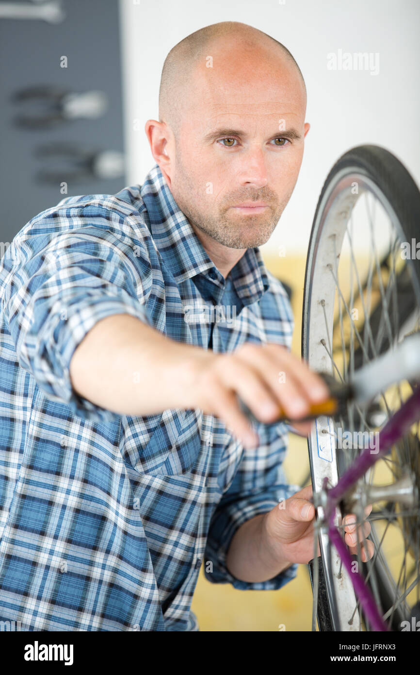 adjusting the bikes chains Stock Photo - Alamy
