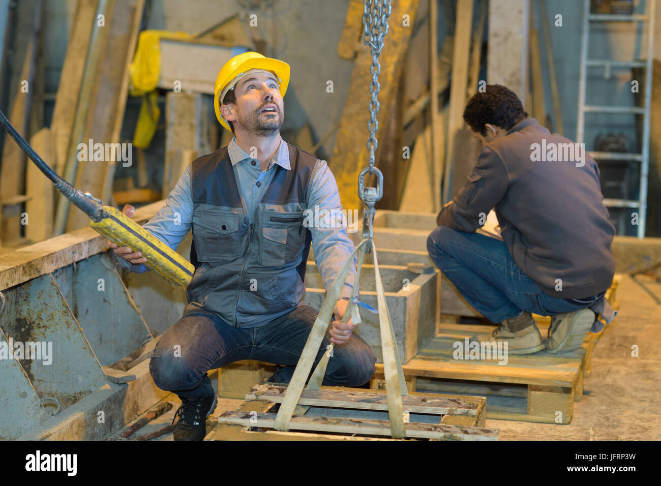 factory workers using a pulley Stock Photo - Alamy