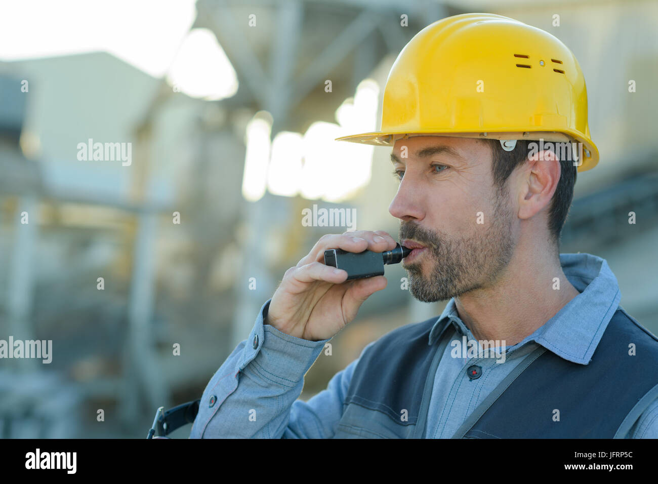 Construction worker smokes cigarette hi-res stock photography and ...