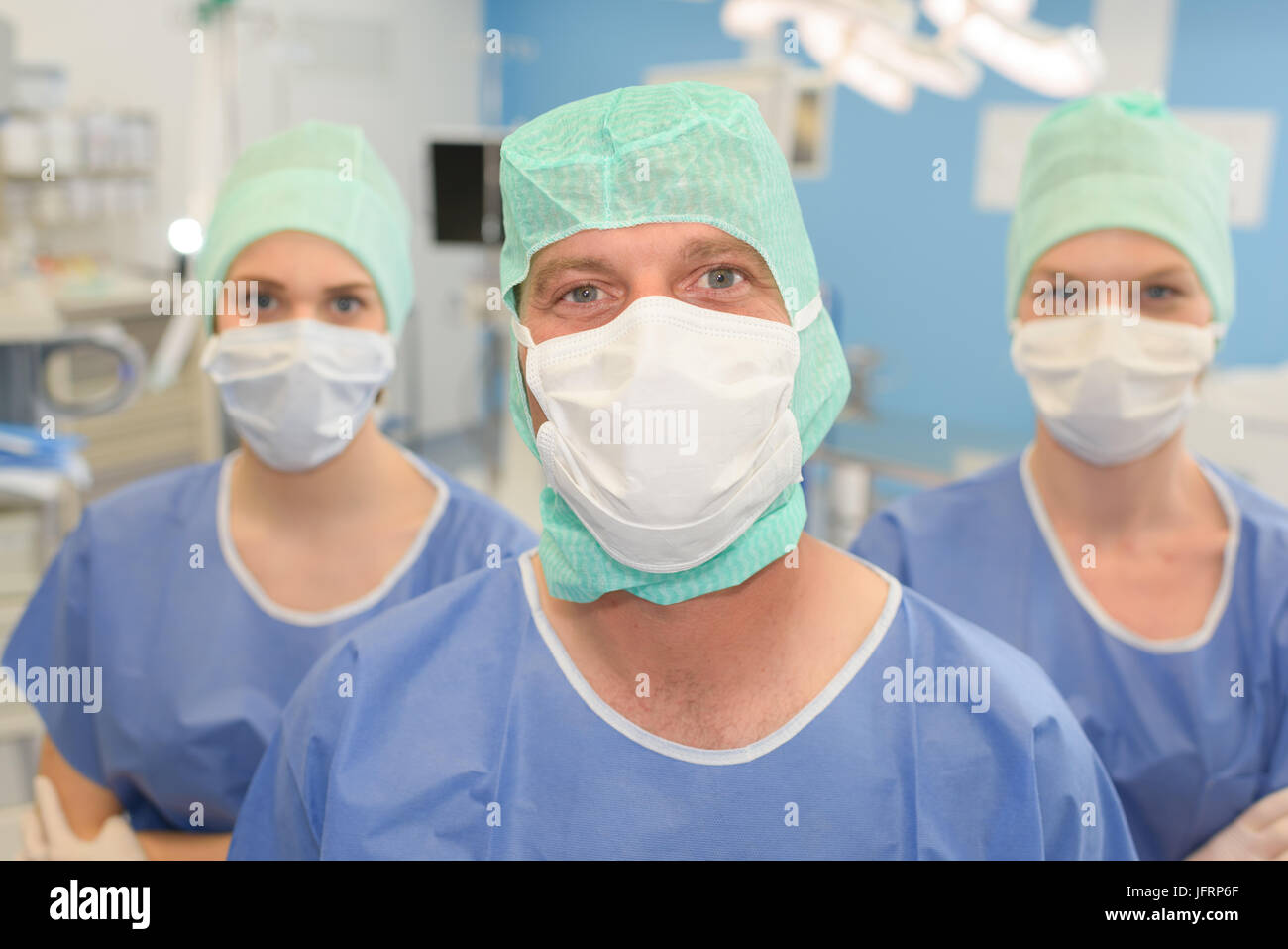 three surgeons in surgical theatre Stock Photo - Alamy