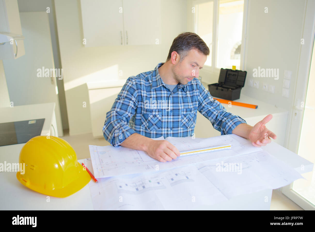 architect concept architects working with blueprints in the office ...
