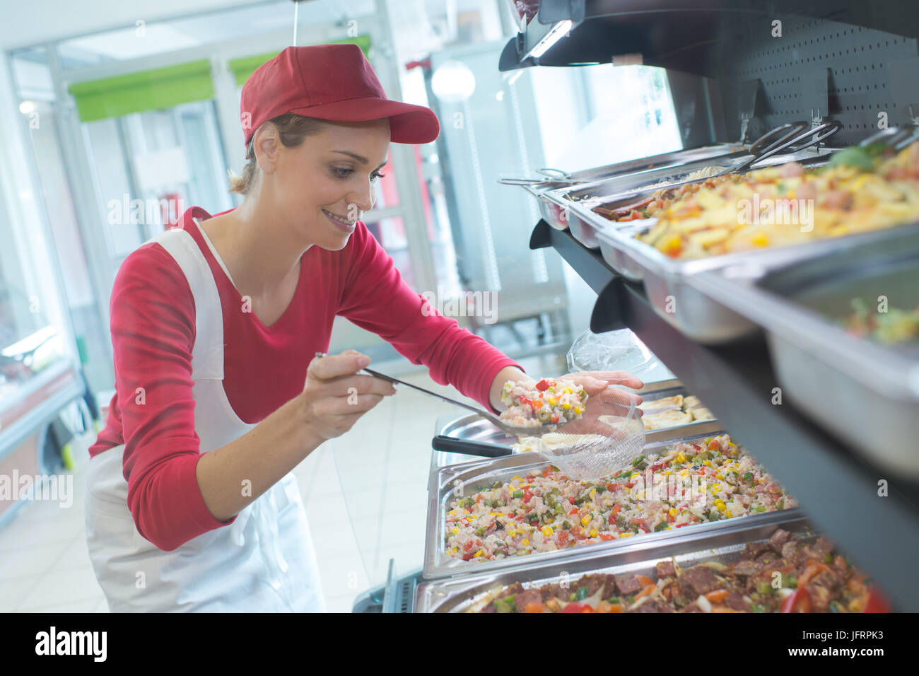 buffet female worker servicing food in cafeteria Stock Photo - Alamy