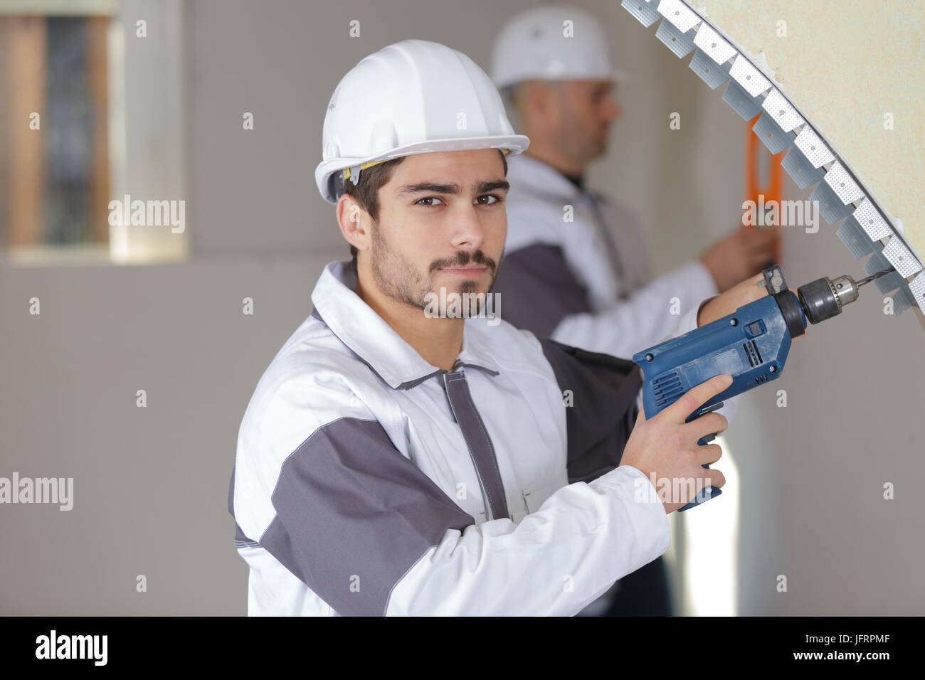 young man with a drill Stock Photo - Alamy